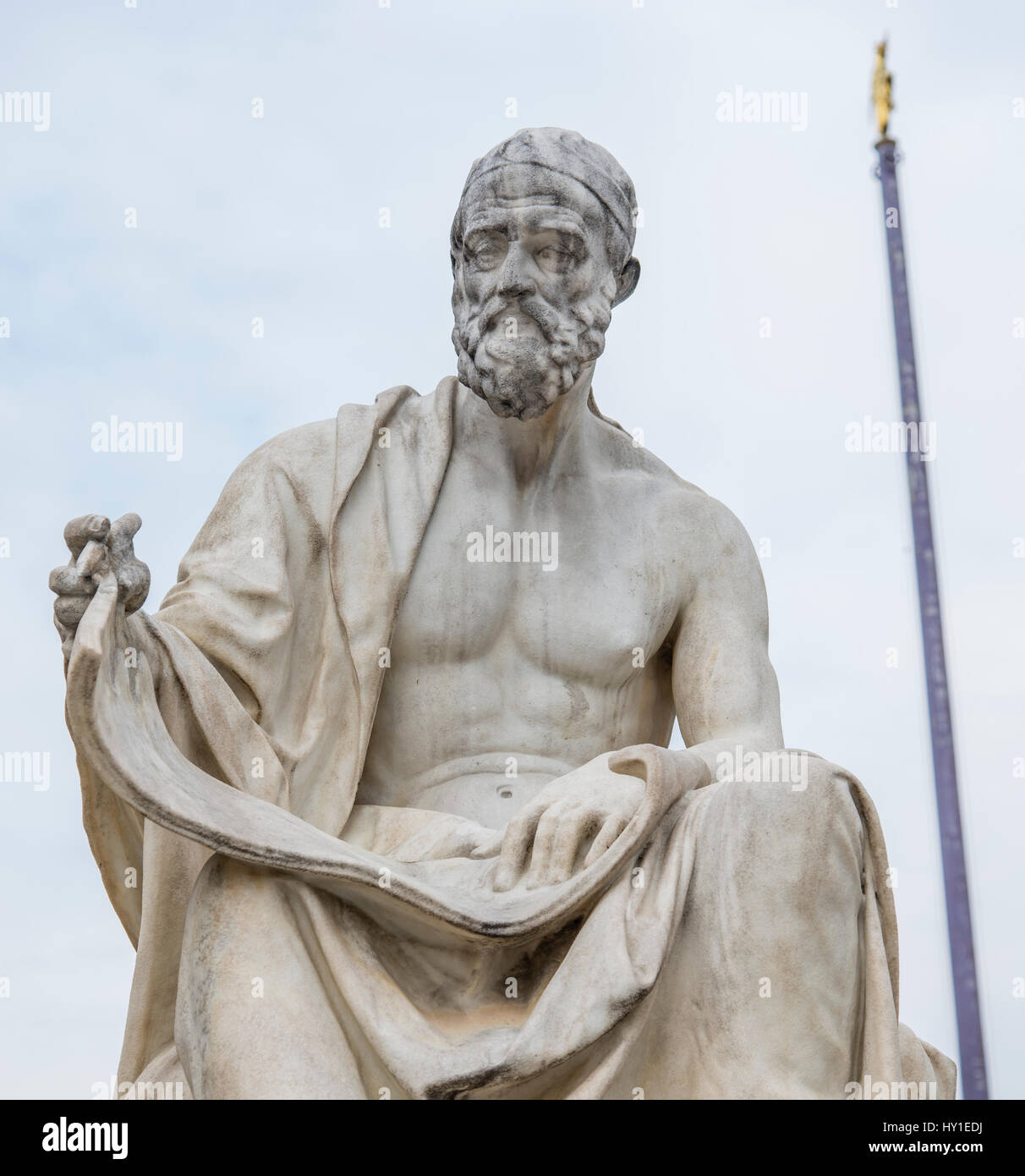 A robed Greek god statue looks up from a scroll Stock Photo - Alamy