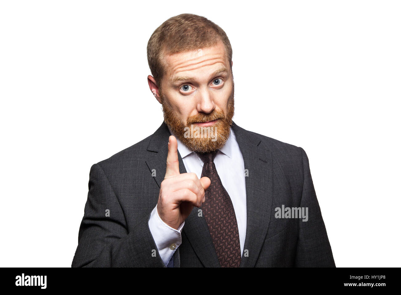 Serious Businessman showing no sign with his finger against a white ...