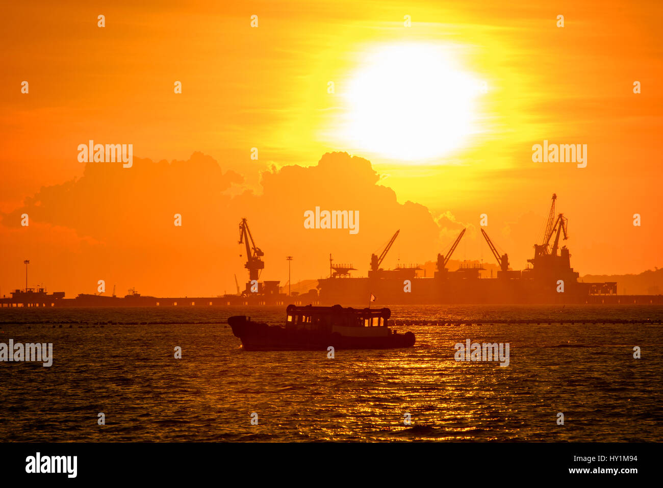 Beautiful sunset scene, commercial dock with ship and cranes in sunset ...