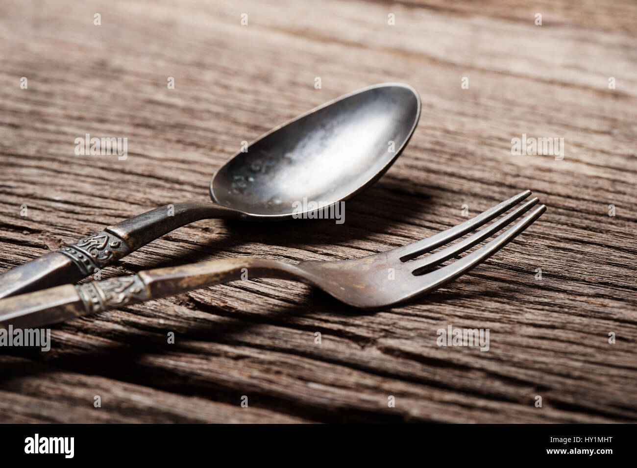 dinning table with old brass spoon and fork Stock Photo - Alamy