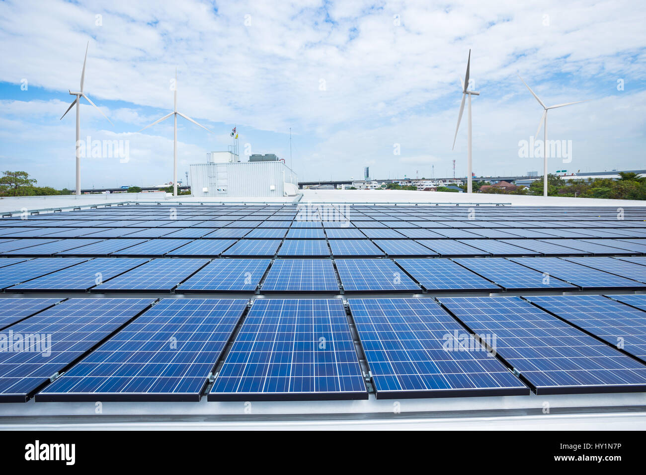 Solar panels on factory roof with wind turbine Stock Photo - Alamy