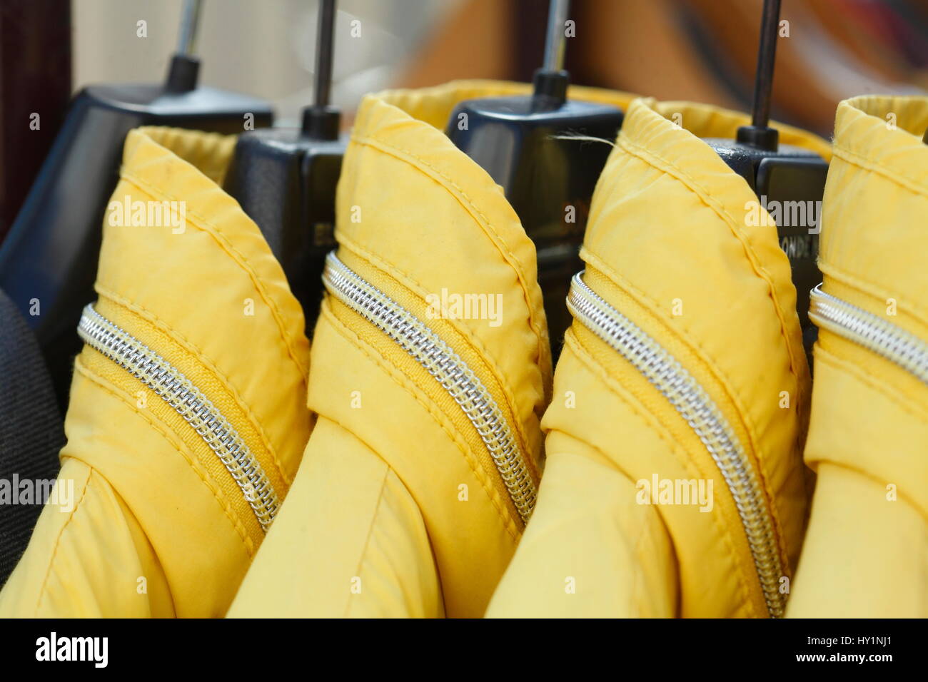Yellow Jackets on a clothes rail Stock Photo - Alamy