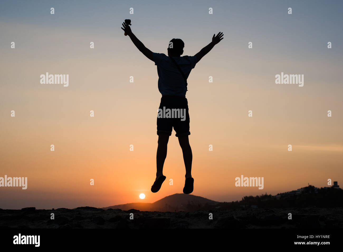 young man Jumping up at Sunset Stock Photo - Alamy