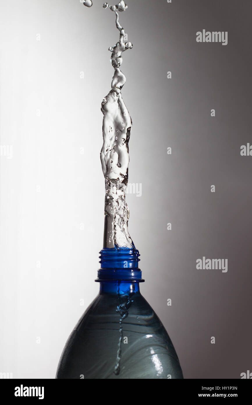 Bottle and splashing water Stock Photo - Alamy