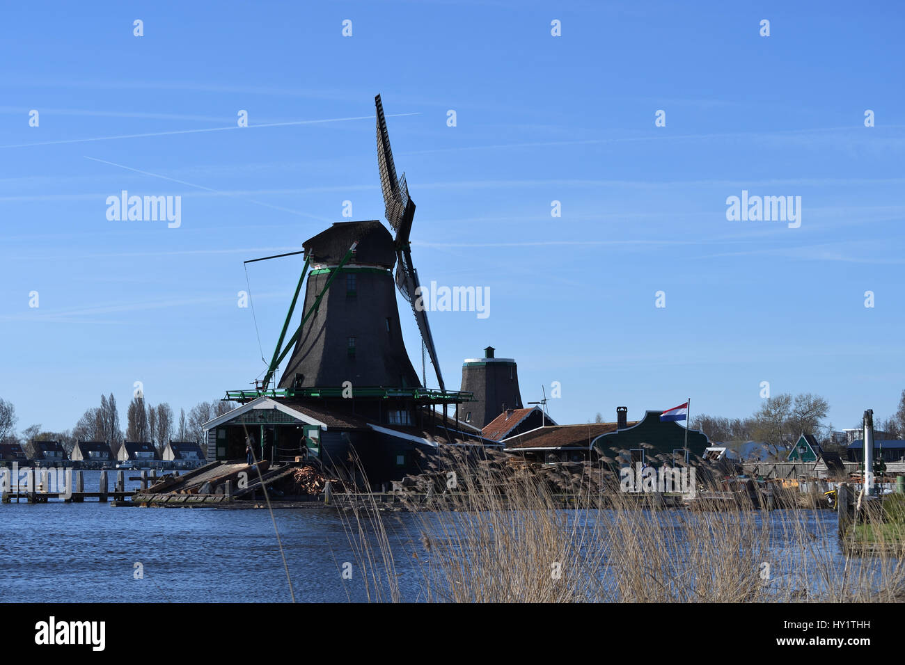 Old style windmill in Dutch countryside on waterway Stock Photo - Alamy
