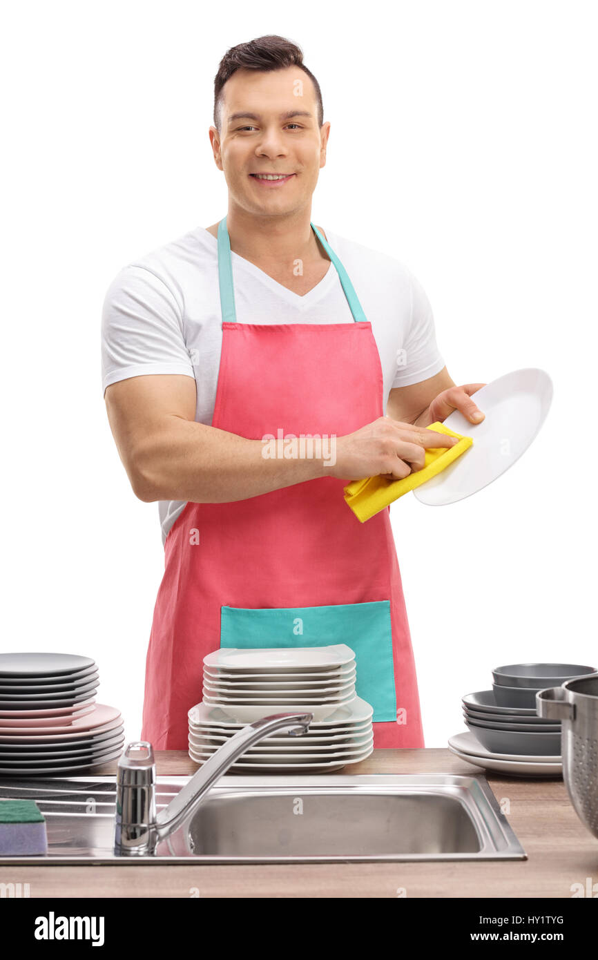 Young guy in an apron wiping dishes isolated on white background Stock ...