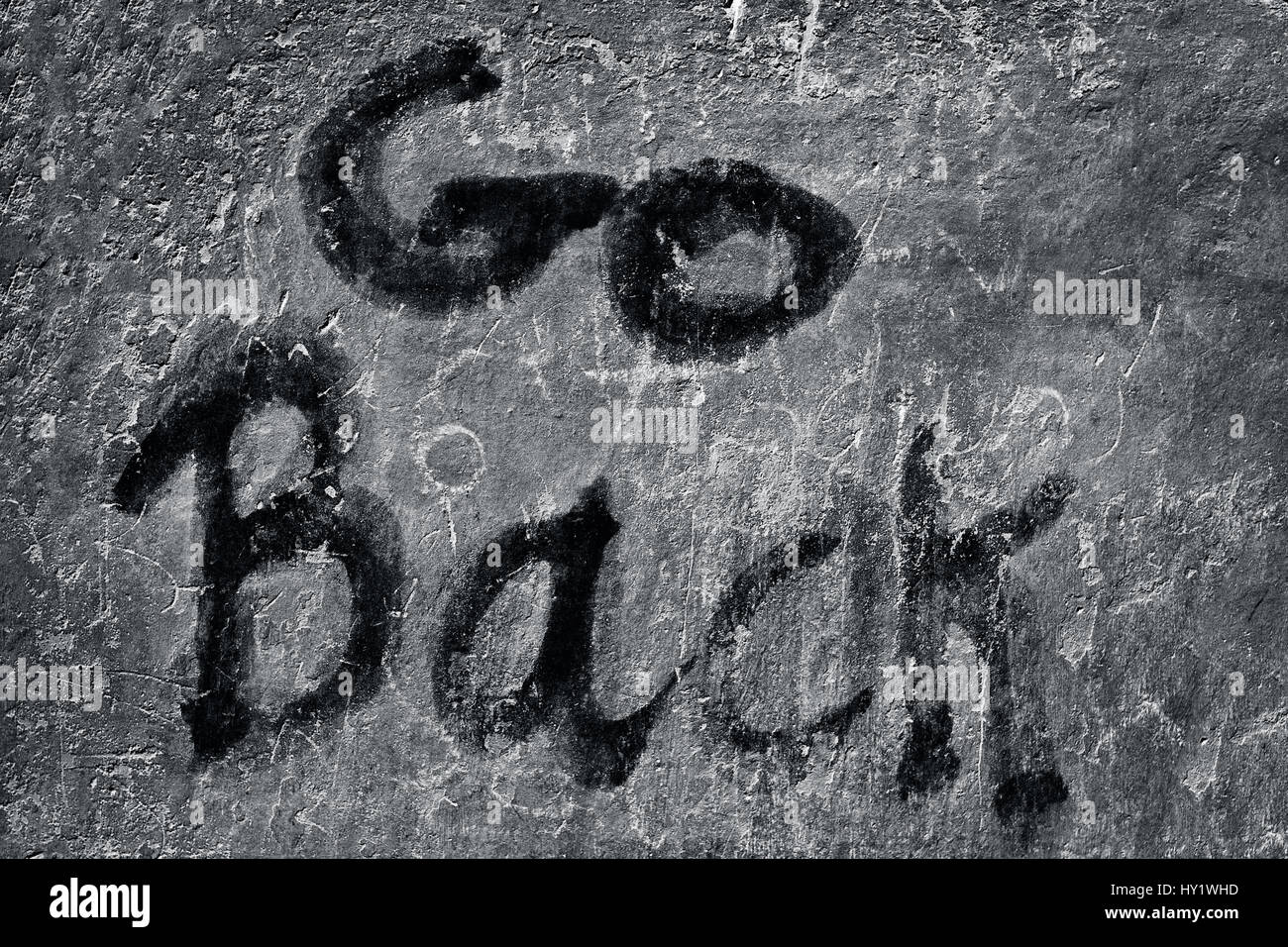 Go Back written on the wall with a paint brush Stock Photo - Alamy