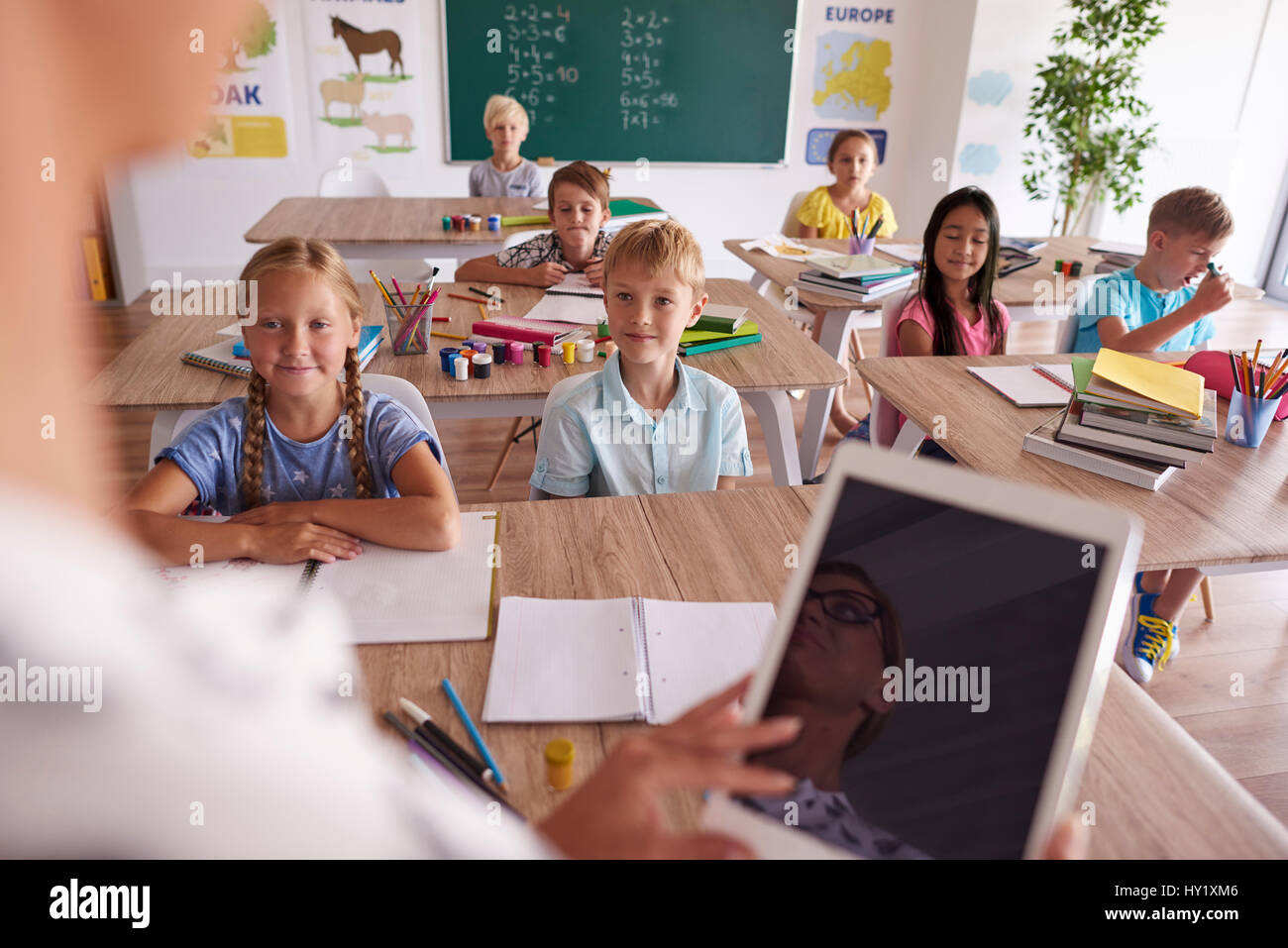 Teacher teaching from digital tablet Stock Photo - Alamy