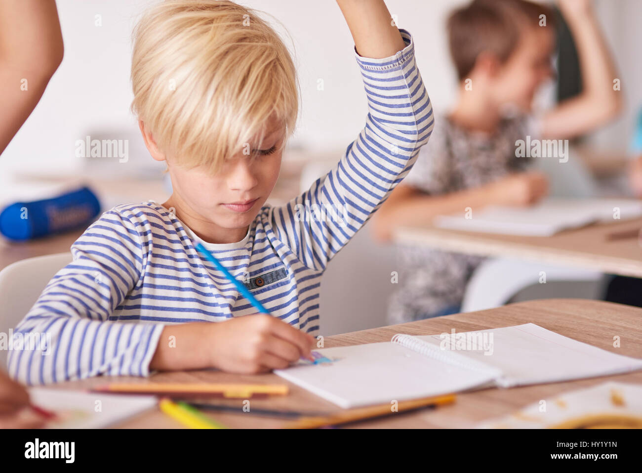Boy drawing and rising his hand Stock Photo - Alamy