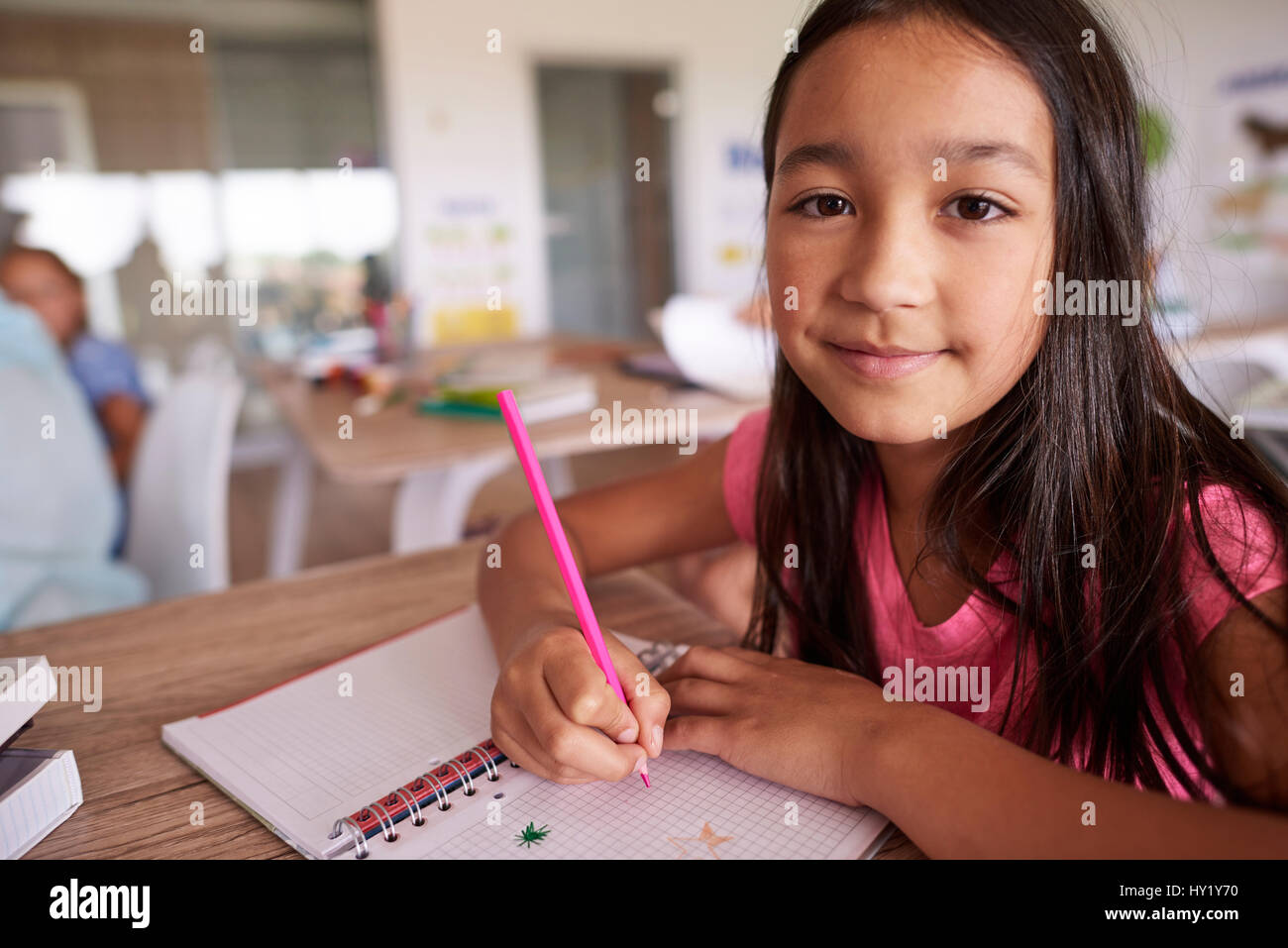 Asian girl creating in her notebook Stock Photo - Alamy