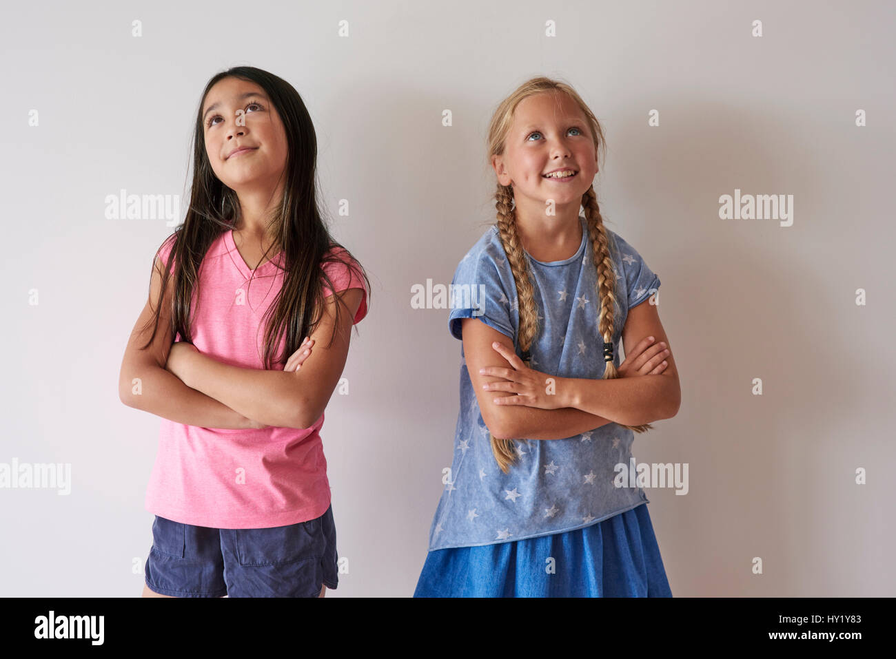 Two girls friends smiling arms hi-res stock photography and images - Alamy