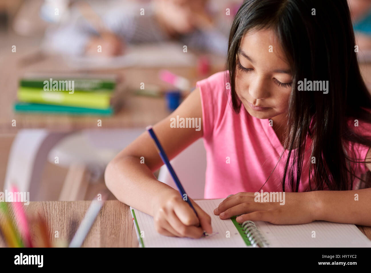 Student sitting at desk during lesson Stock Photo - Alamy