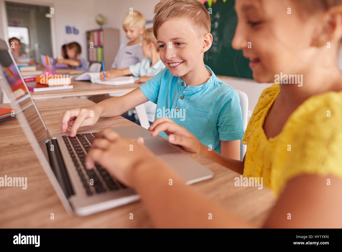 Two kids using laptop during lesson Stock Photo - Alamy
