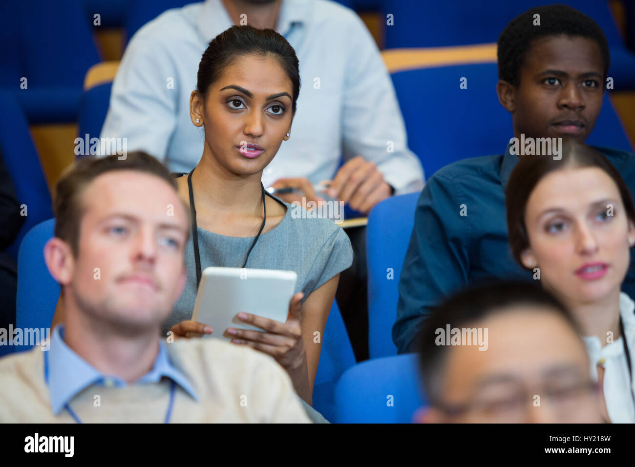 Business executive participating in a business meeting taking notes at ...