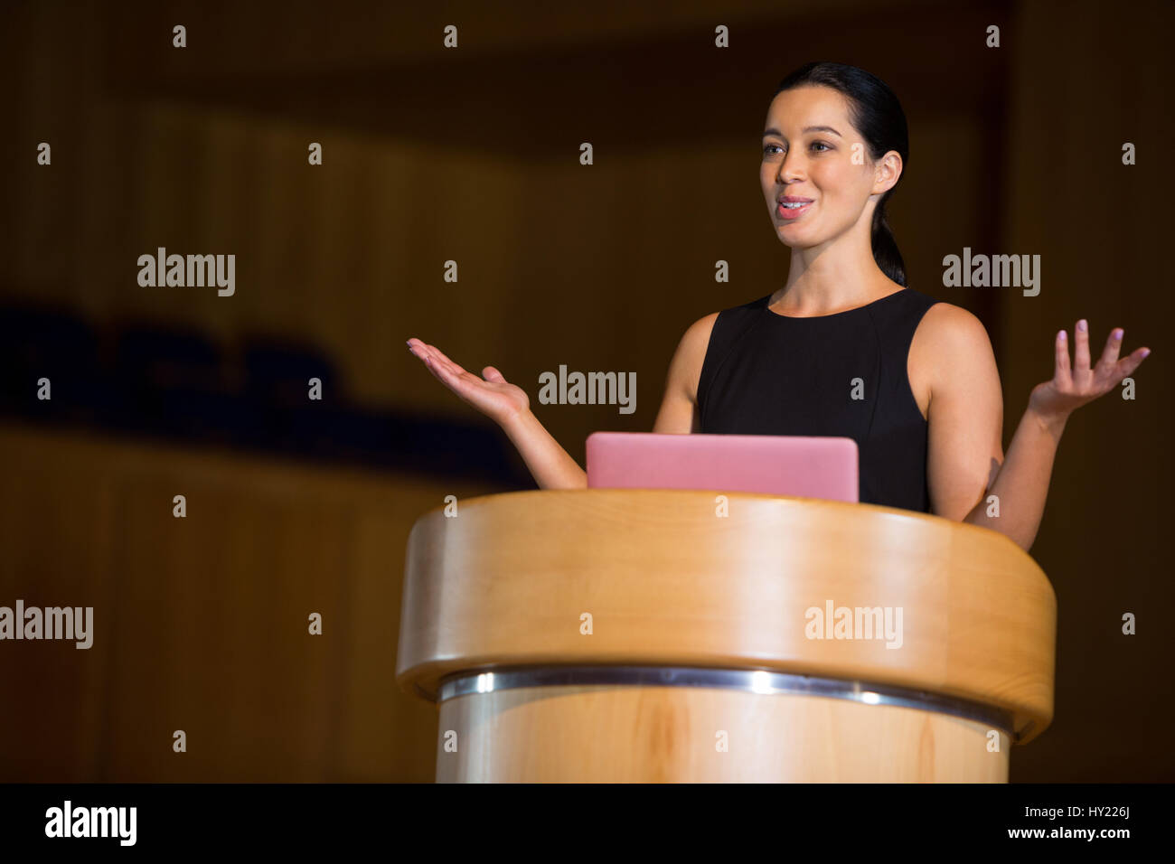 Female business executive giving a speech at conference center Stock ...