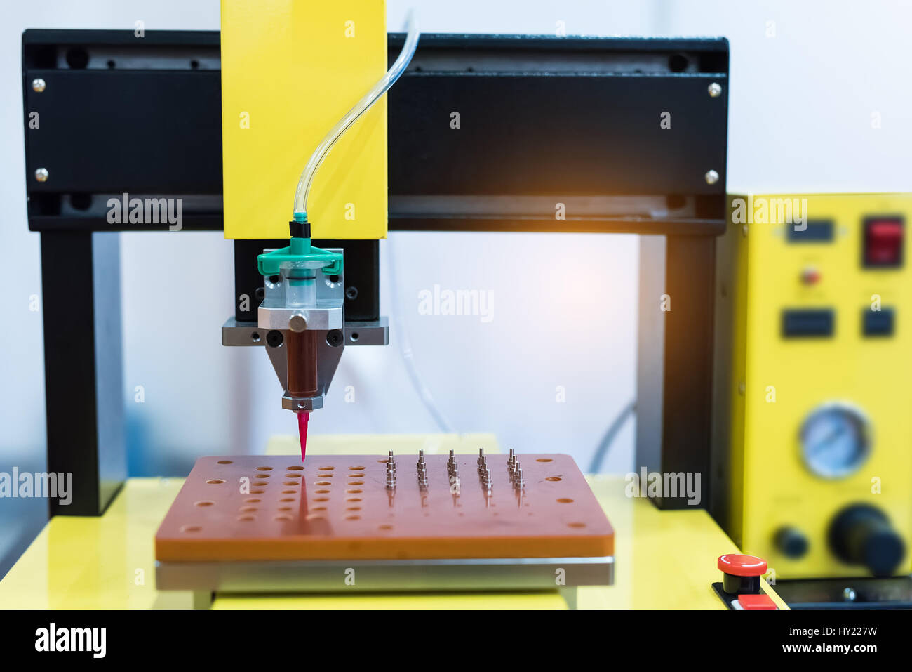 Robot holding glue syringe Injection Stock Photo - Alamy