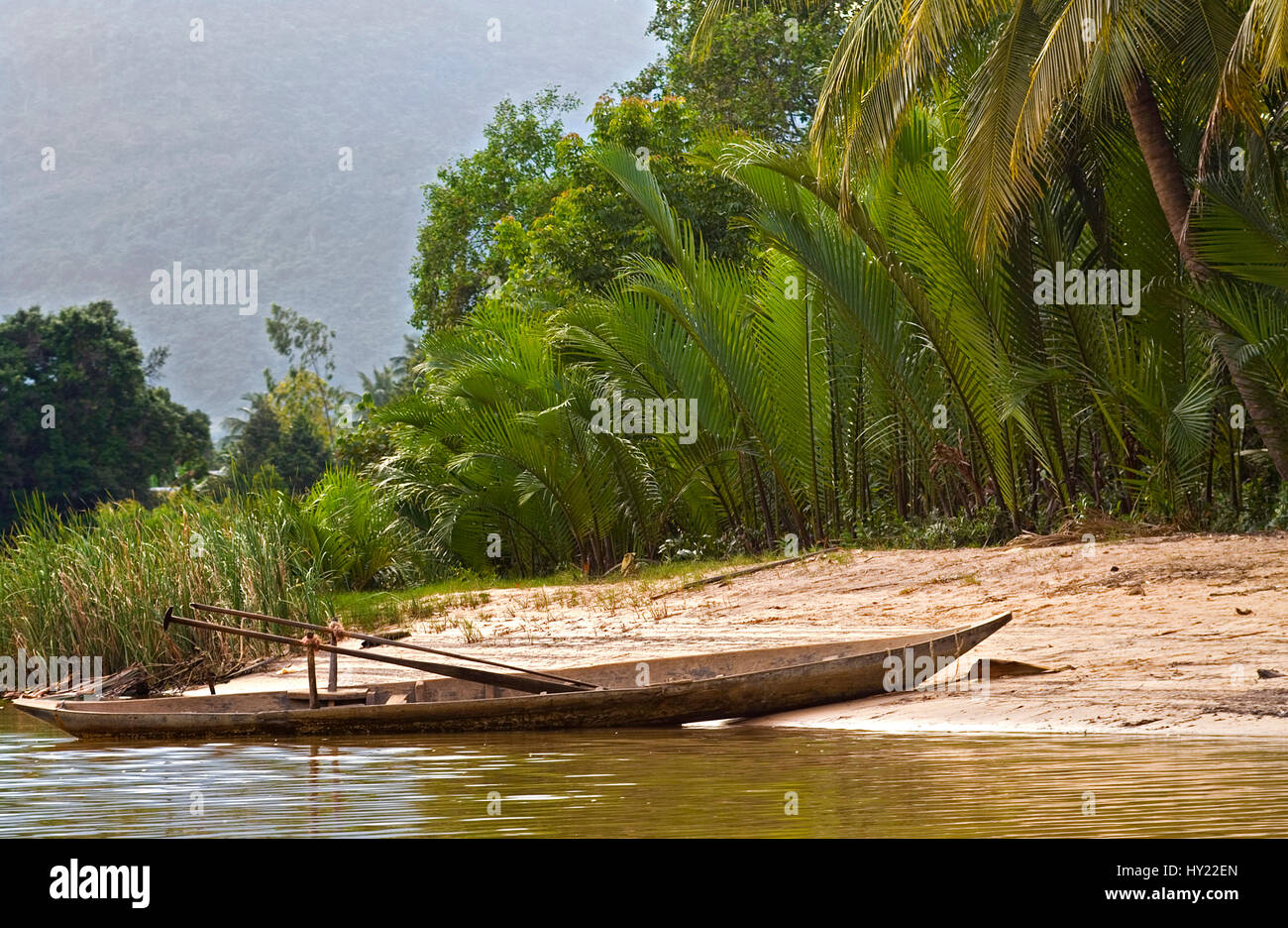 This stock photo shows a single wooden rowing boat at the bank of the ...