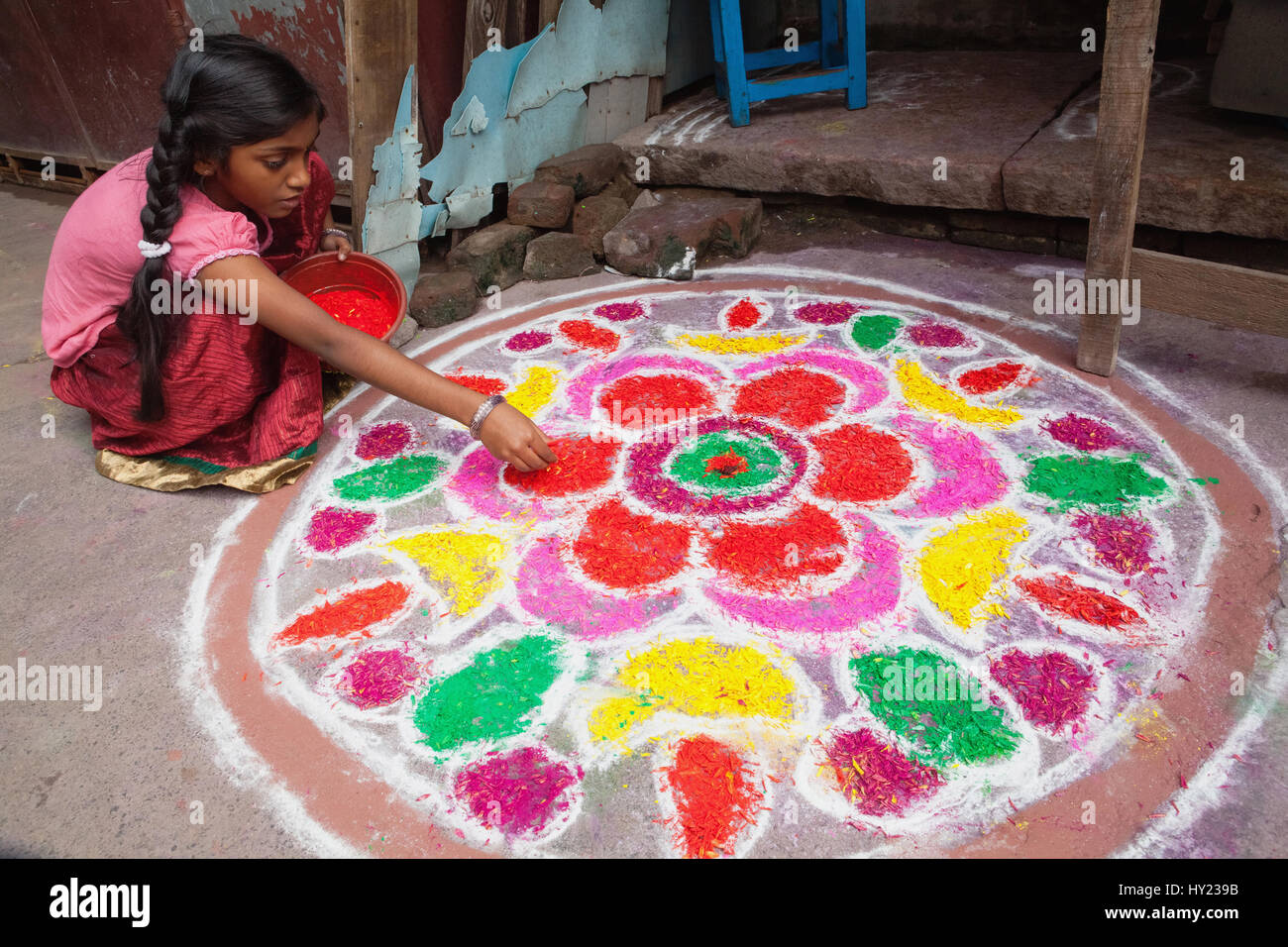 India, Tamil Nadu, Kumbakonam, A girl making a rangoli to celebrate the ...
