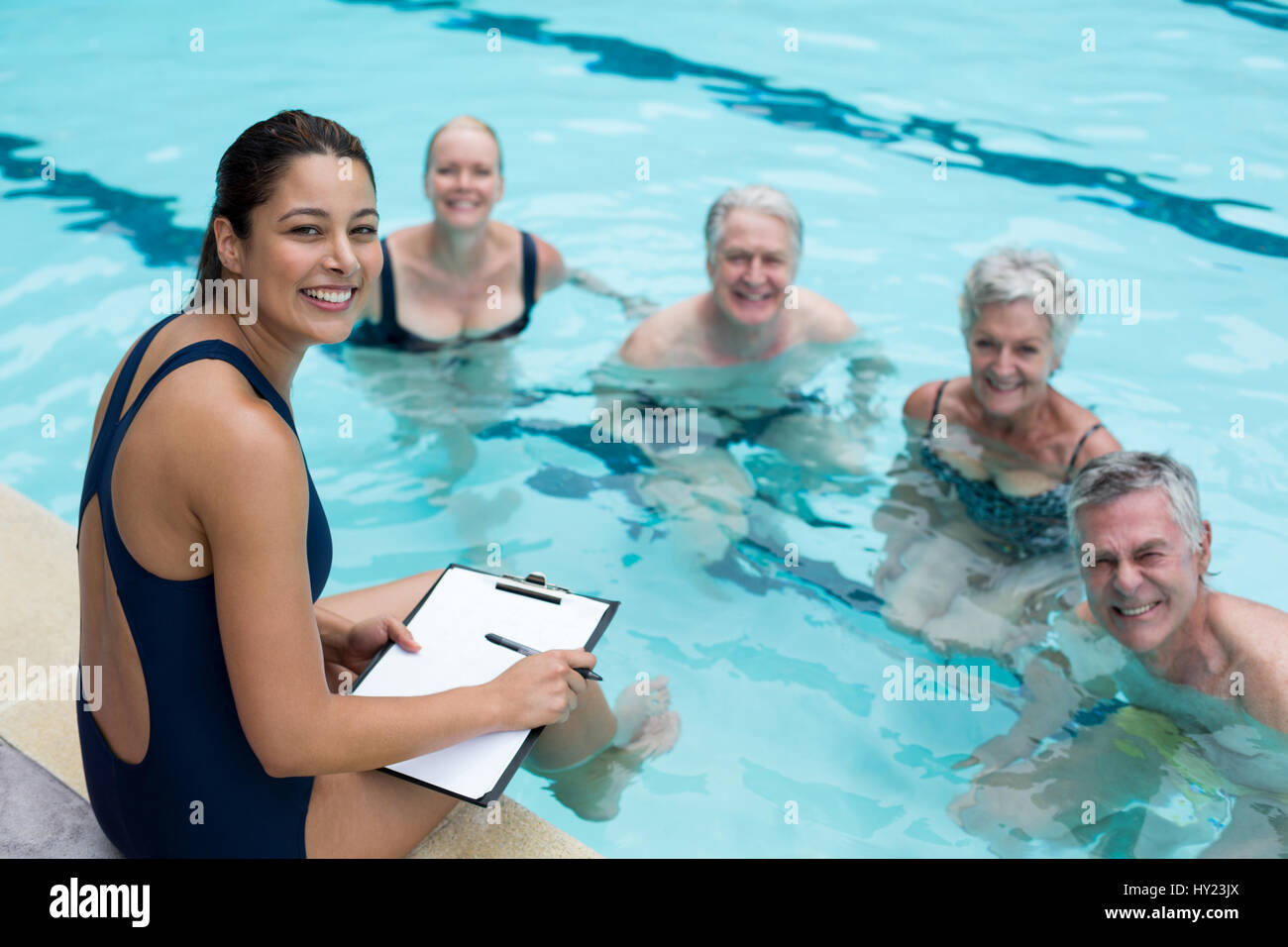 Portrait of happy female trainer and senior swimmers Stock Photo - Alamy
