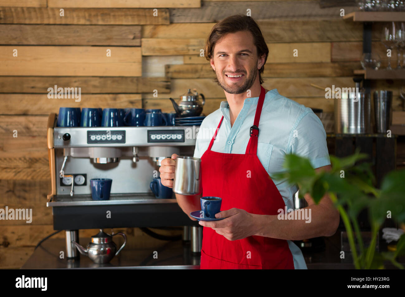 Portrait of smiling male barista making coffee in cafe Stock Photo - Alamy