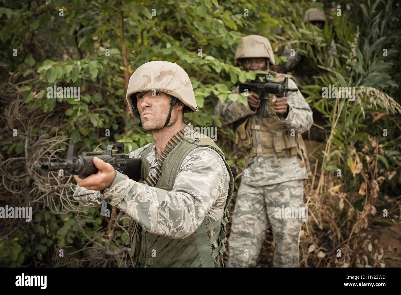 Military soldiers during training exercise with weapon at boot camp ...