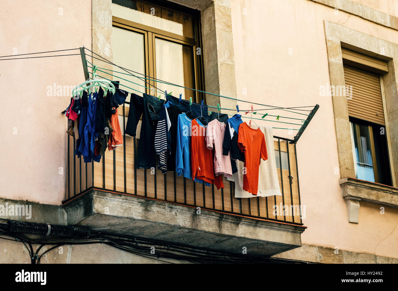 Colorful fresh laundry on the balcony of old house in Barcelona ...