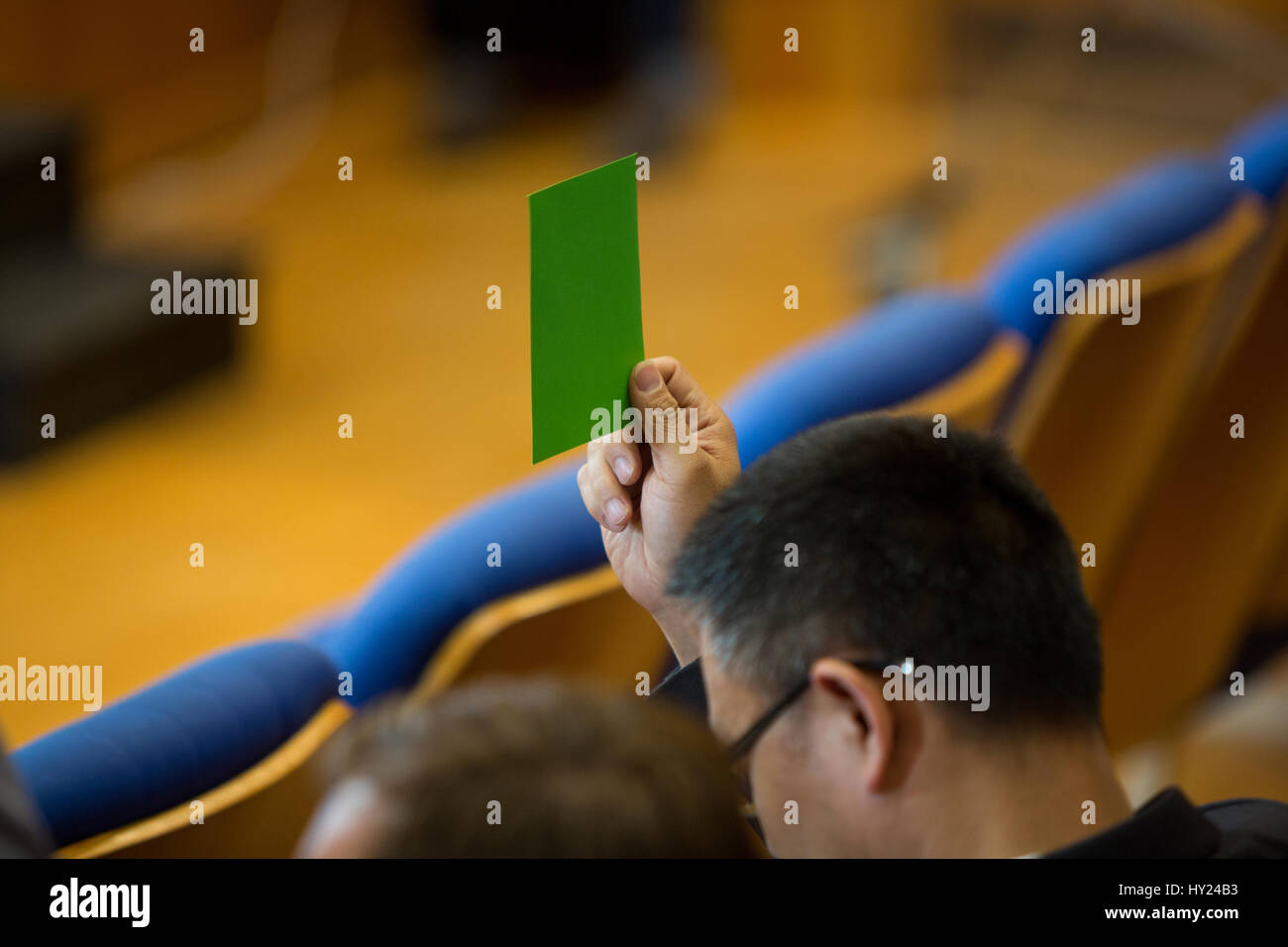 Business executive his approval by raising hand at conference center ...