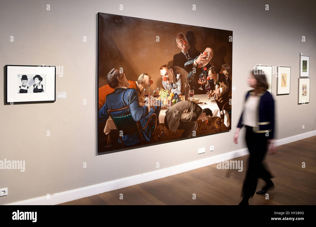 Hanover, Germany. 31st Mar, 2017. A woman walks past a cartoon by ...