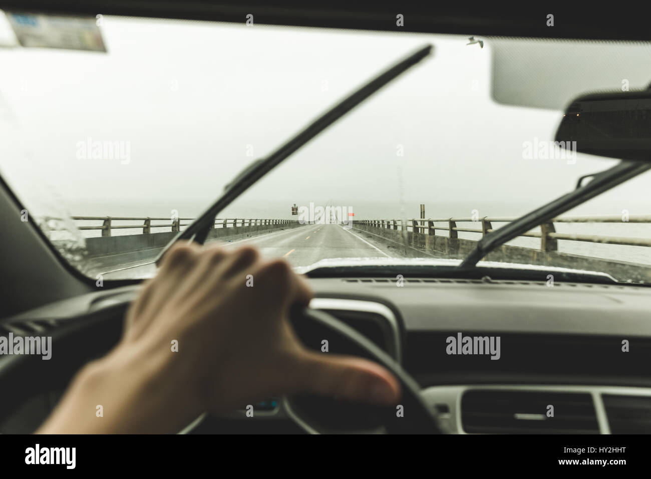 Driver's point of view inside car cruising down two-lane bridge in ...