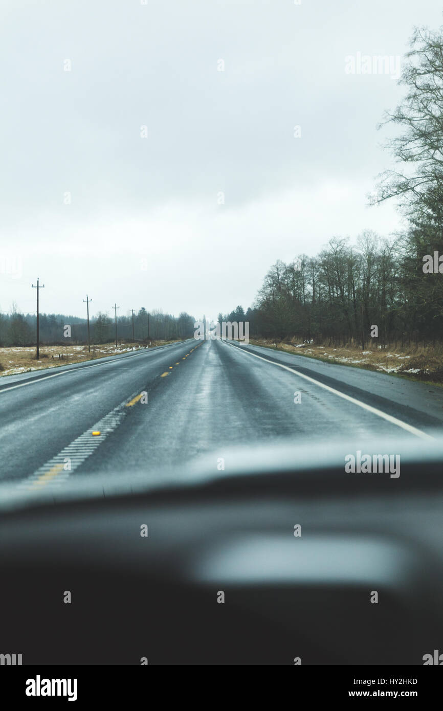 Driver's point of view on a wet, shiny road near the coast in western ...