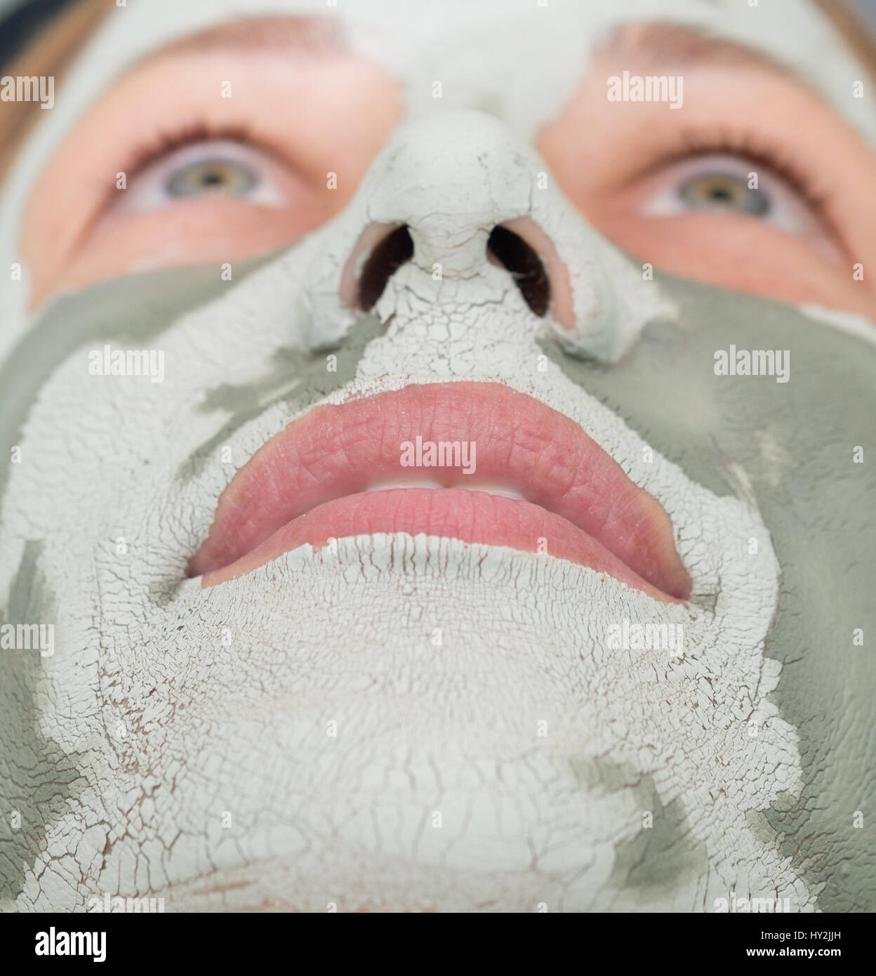 young beautiful woman with clay mask on her face Stock Photo - Alamy