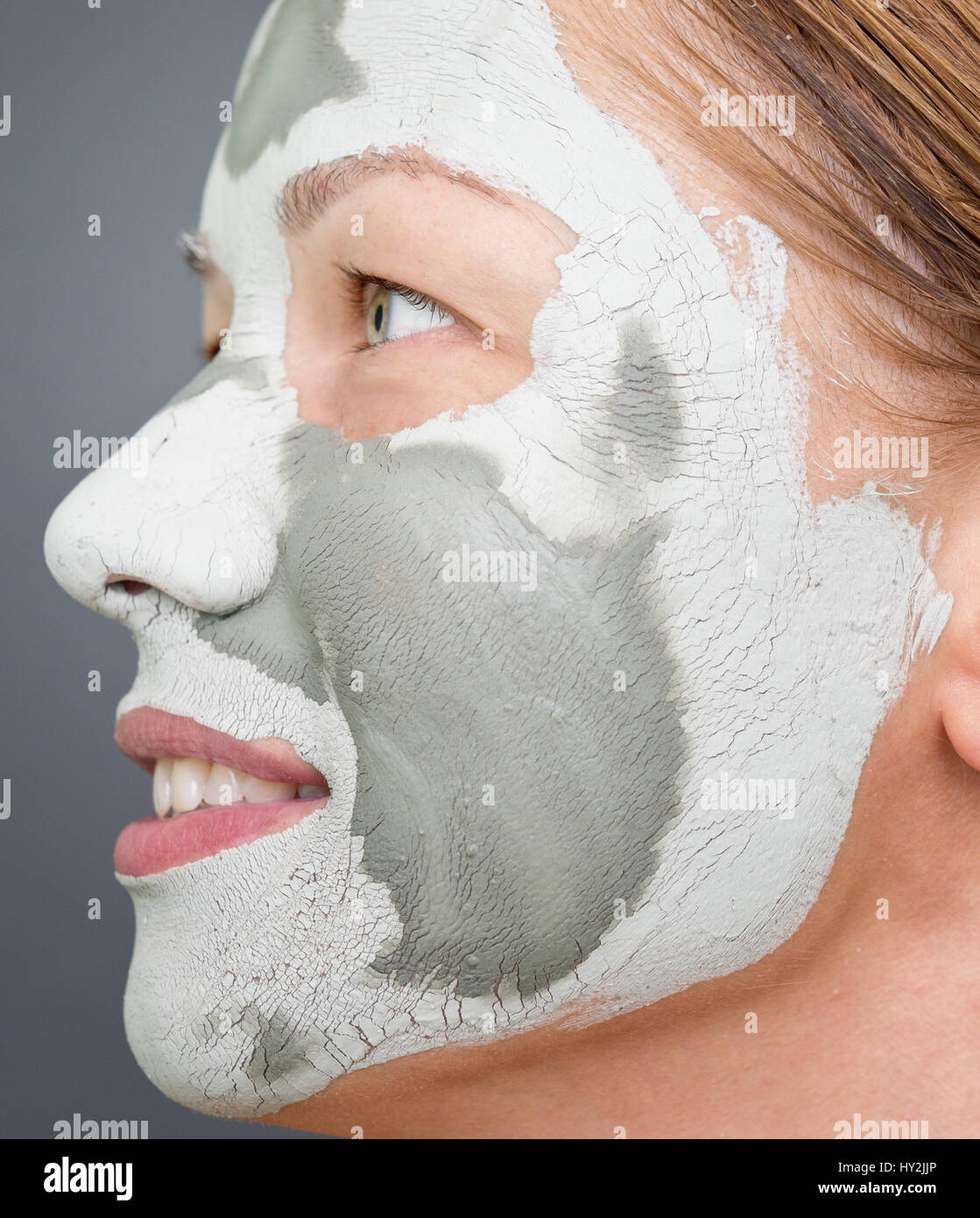 young beautiful woman with clay mask on her face Stock Photo - Alamy