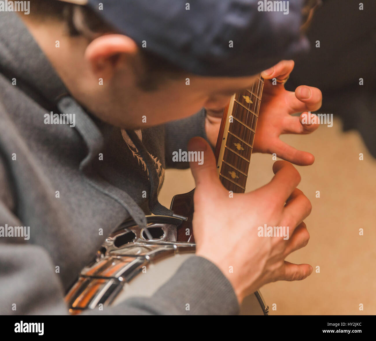 Man playing banjo in a recording space or jam room Stock Photo - Alamy