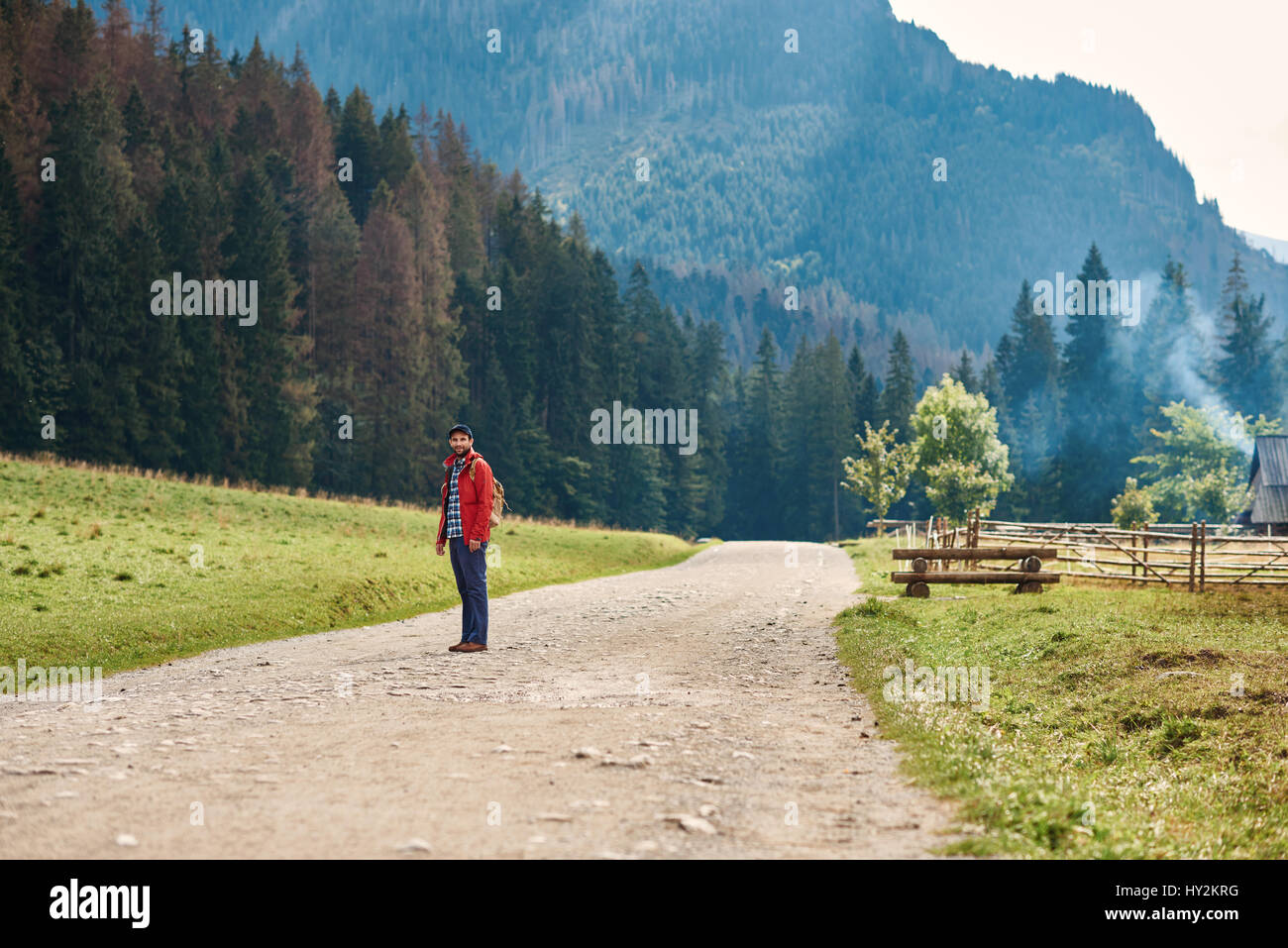 Young man standing on a path in the great outdoors Stock Photo - Alamy