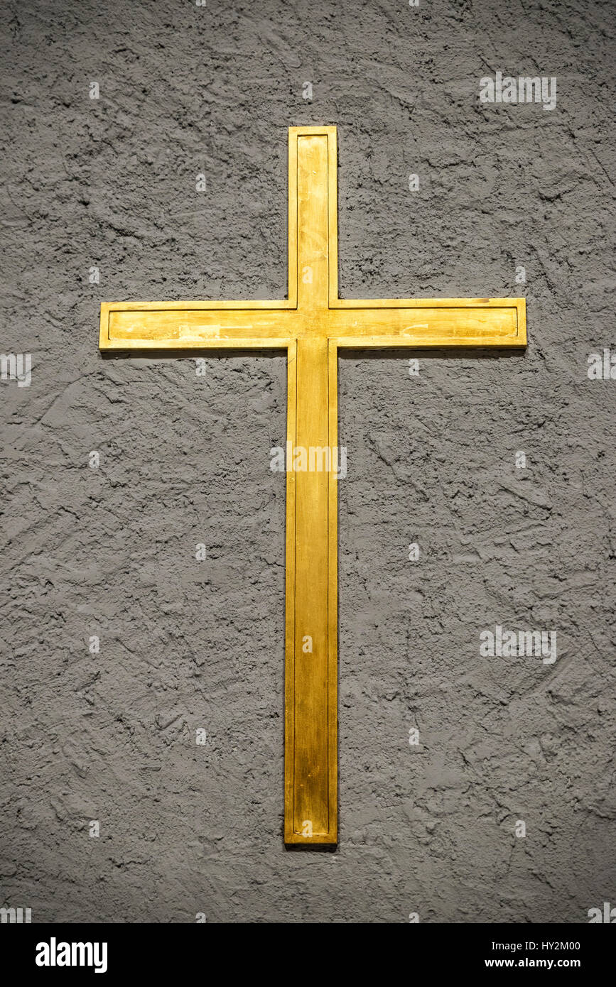 Christian golden cross on a concrete wall in a church in Rome, Italy ...