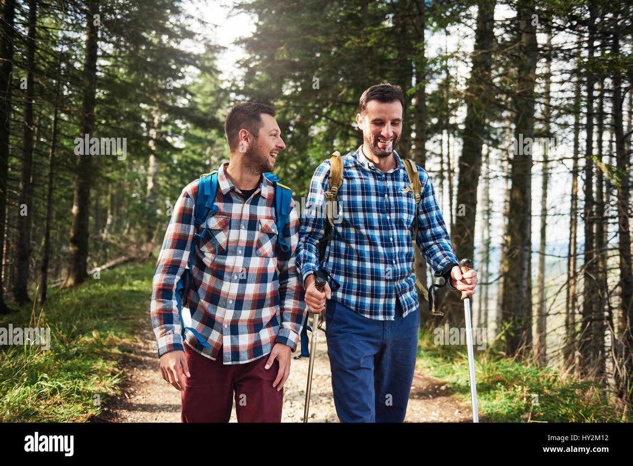 Two friends talking together on a trail in the forest Stock Photo - Alamy