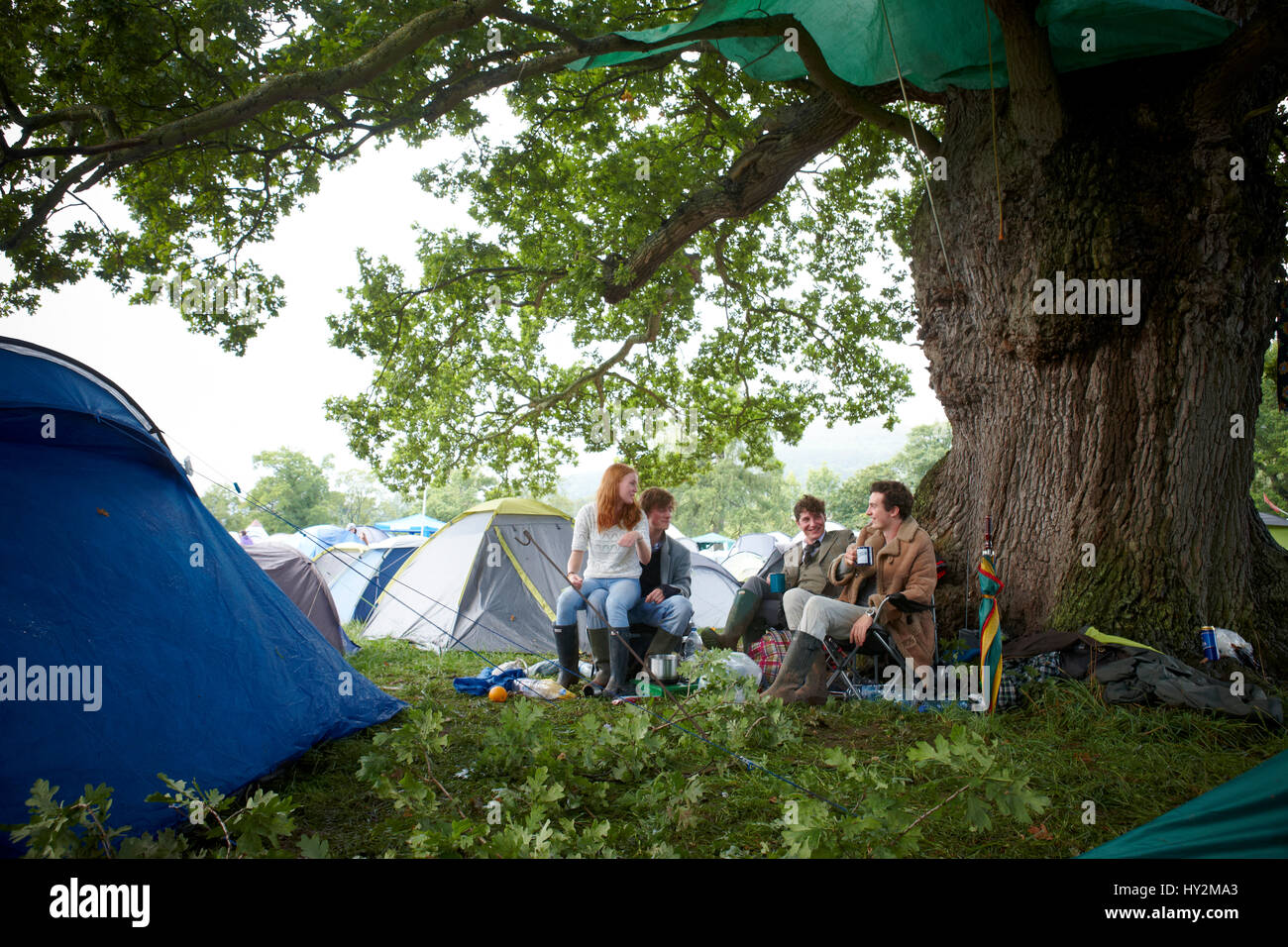 Group people sitting under tree hi-res stock photography and images - Alamy