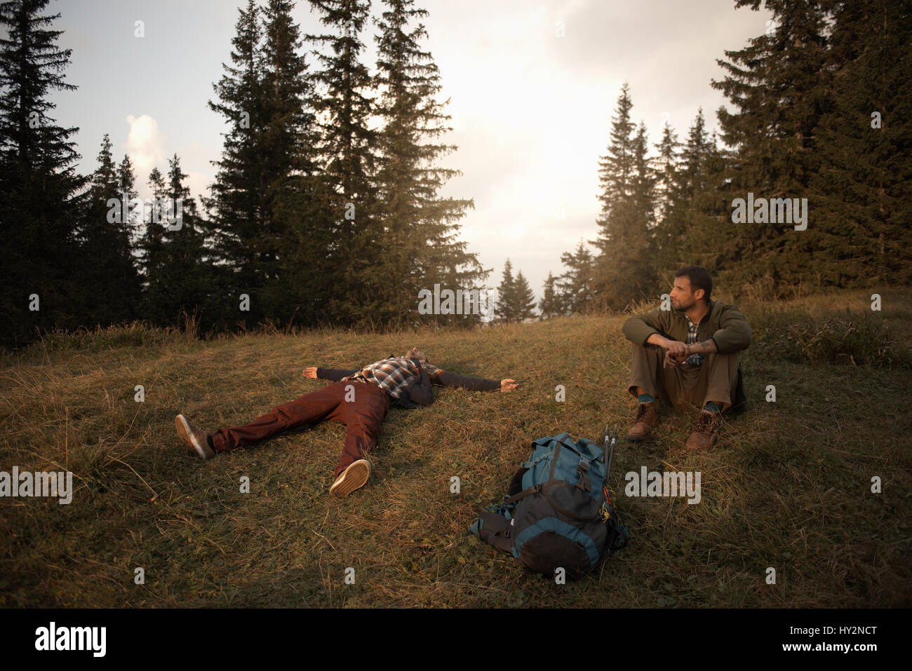 Hikers resting on grass after a long wilderness trek Stock Photo - Alamy
