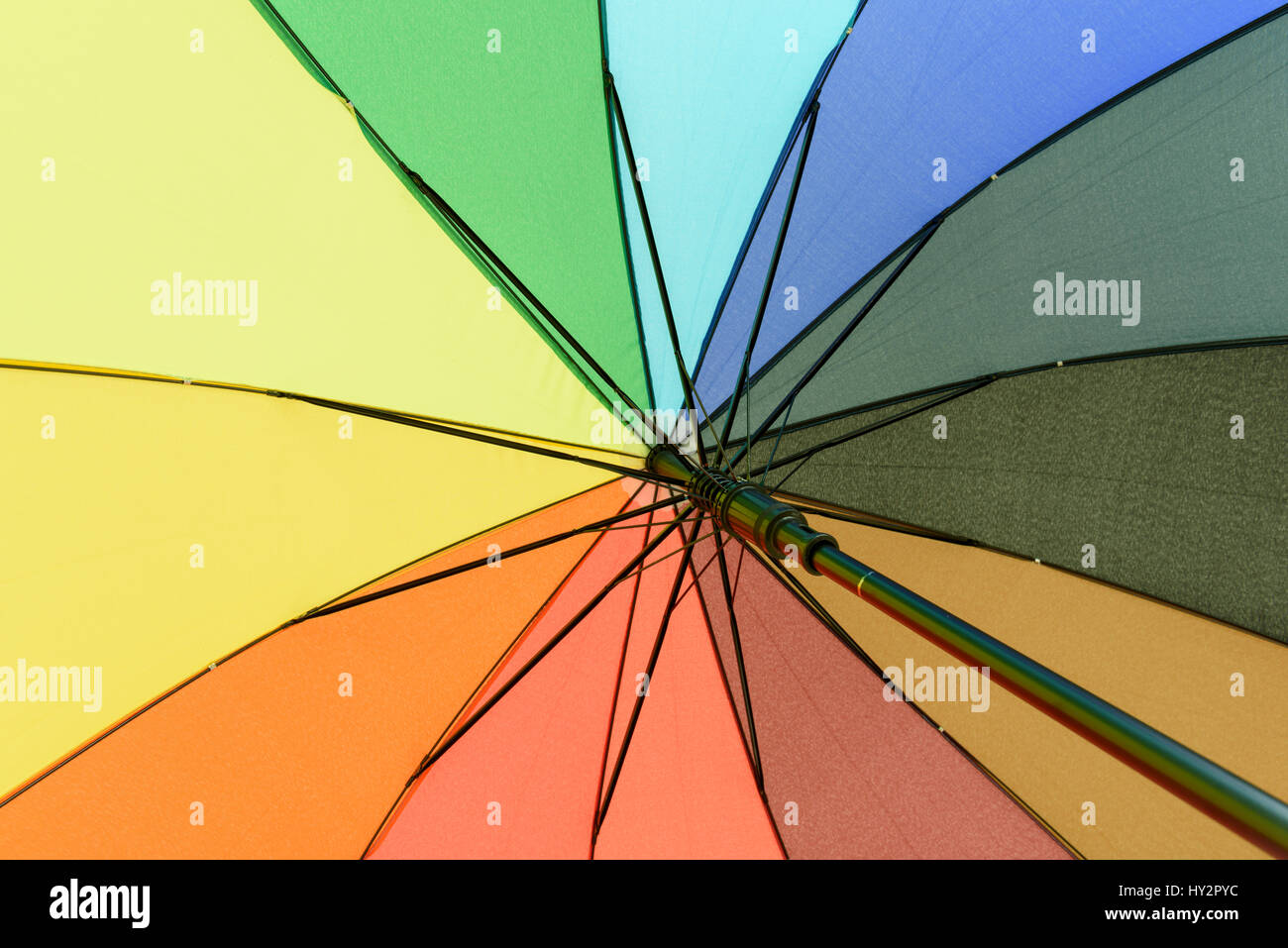 Multi colored umbrella which will protect its user from rain underneath ...