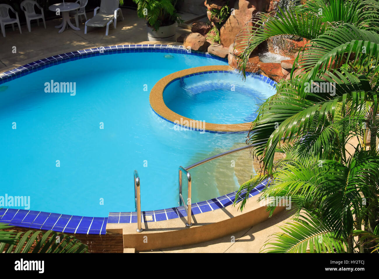Closeup of elegant empty water pool with blue water near palm Stock ...
