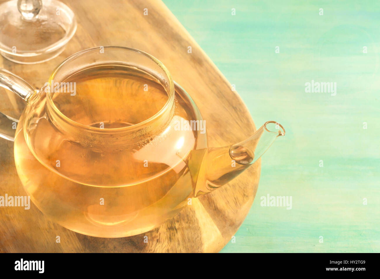 Teapot full of tea on teal texture with copyspace Stock Photo - Alamy