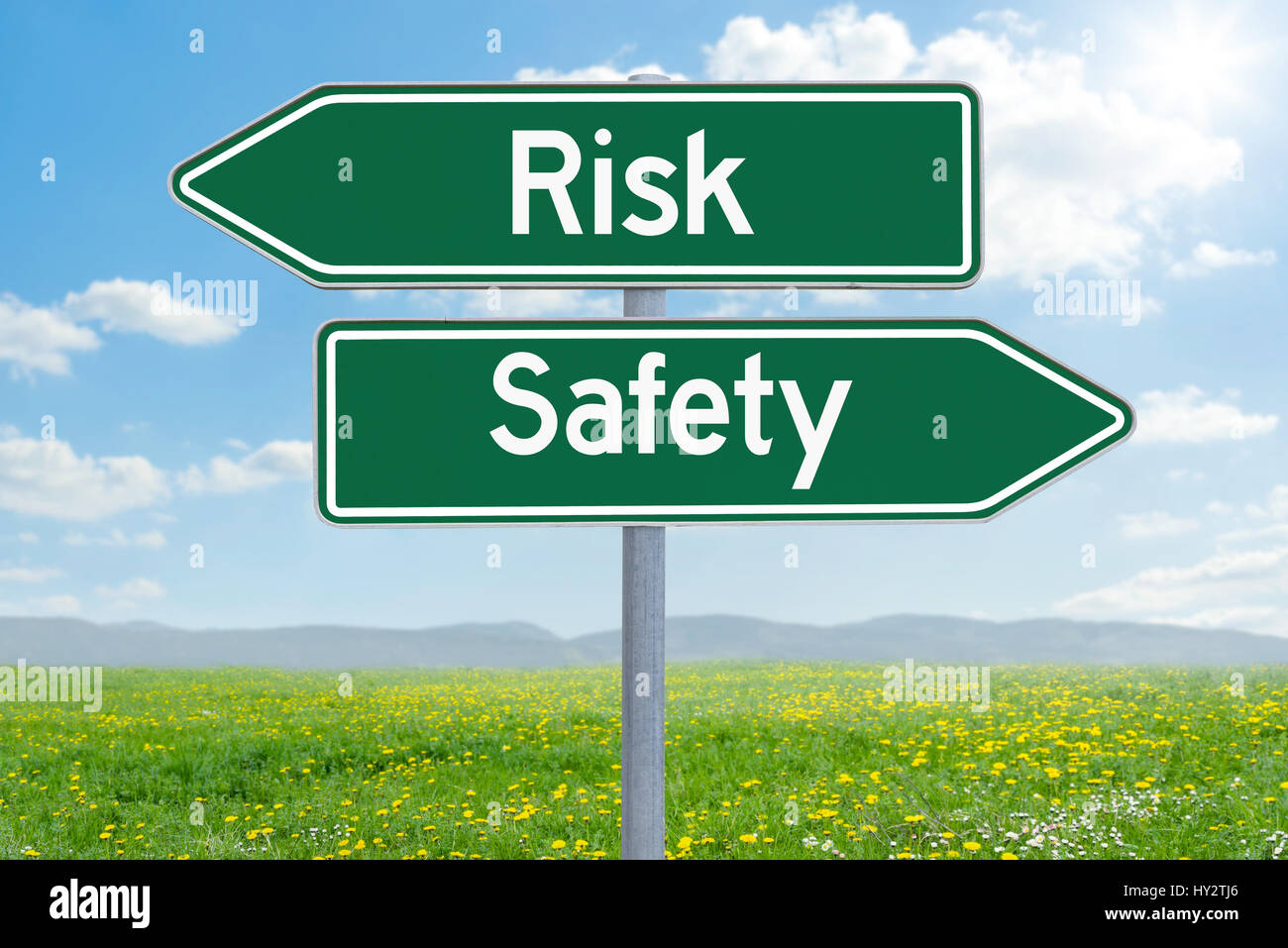 Two green direction signs - Risk or Safety Stock Photo - Alamy