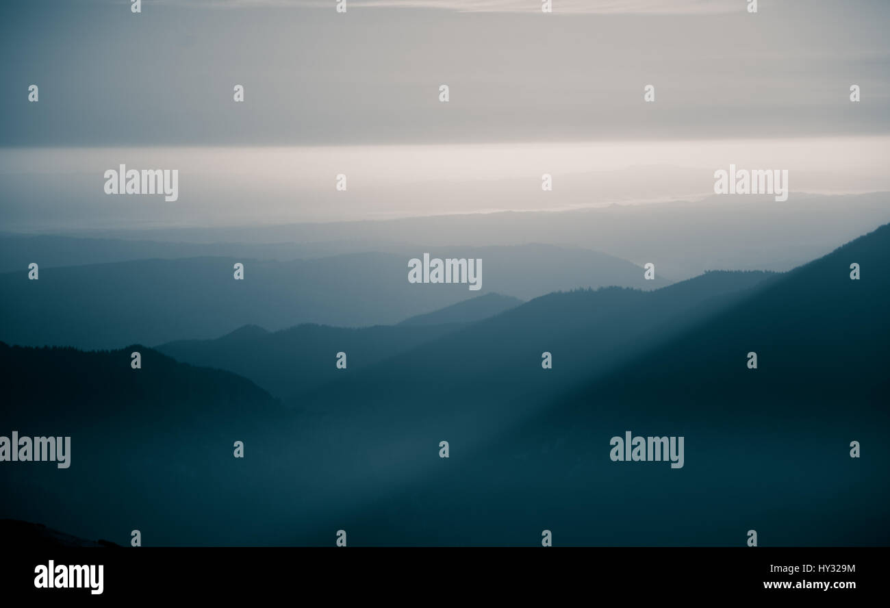 A beautiful, abstract monochrome mountain landscape in blue tonality ...