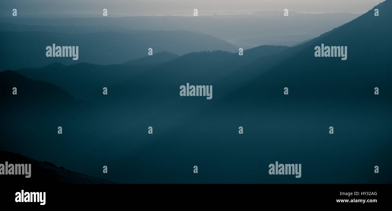 A beautiful, abstract monochrome mountain landscape in blue tonality ...