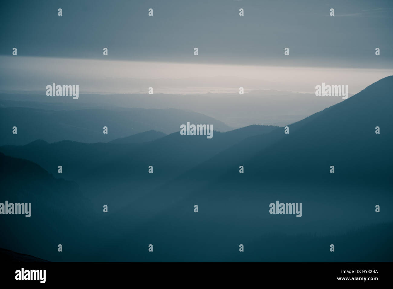 A beautiful, abstract monochrome mountain landscape in blue tonality ...