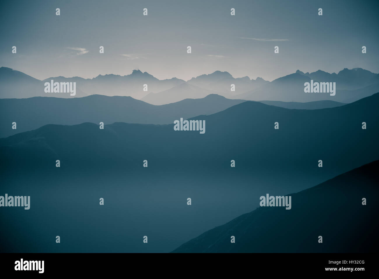 A beautiful, abstract monochrome mountain landscape in blue tonality ...
