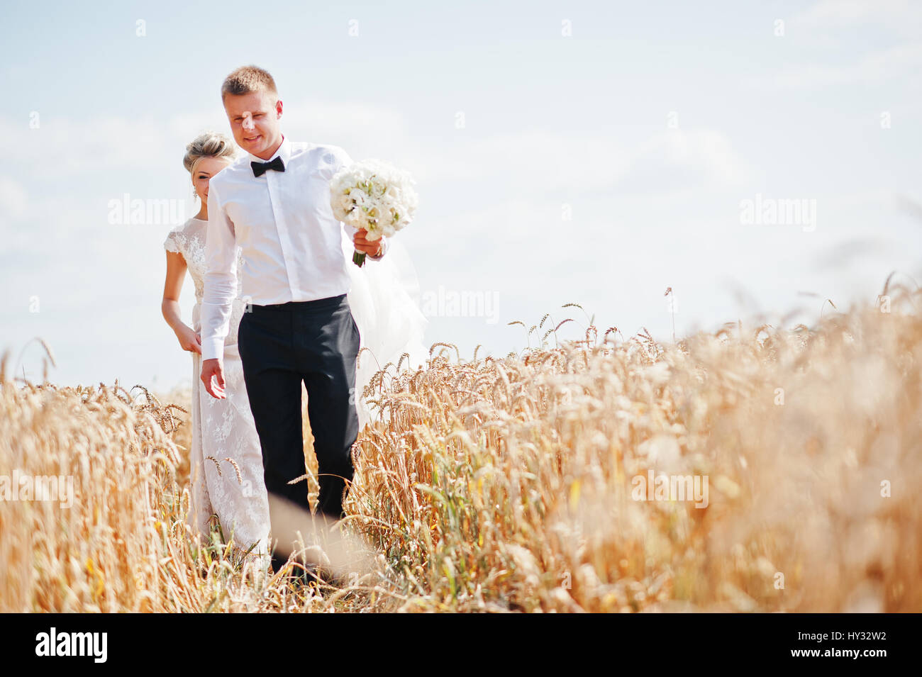 Wedding couple at field of wheat in love Stock Photo - Alamy