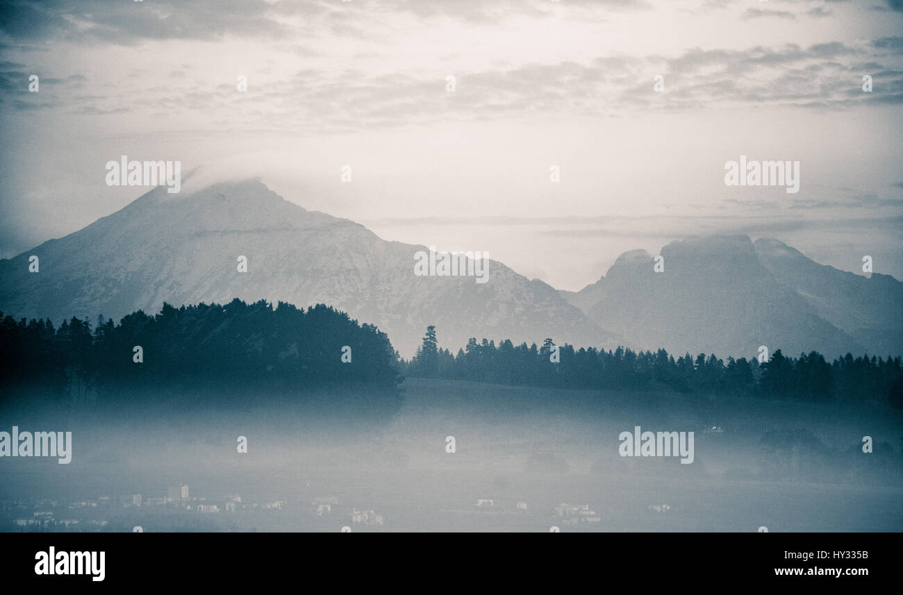 A beautiful, abstract monochrome mountain landscape in blue tonality ...