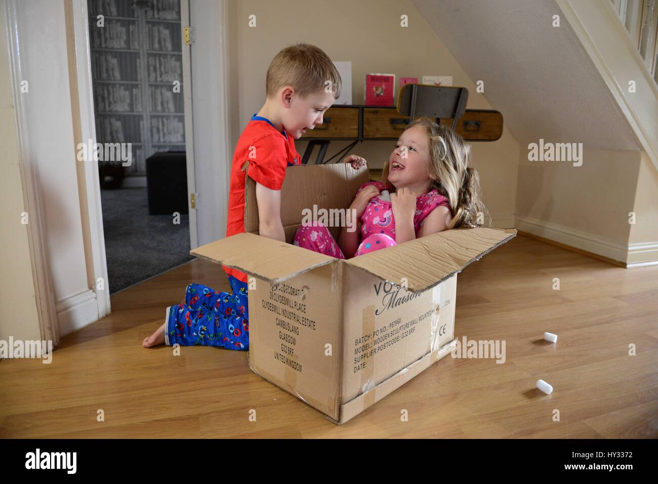 Children playing with an empty cardboard box Stock Photo - Alamy