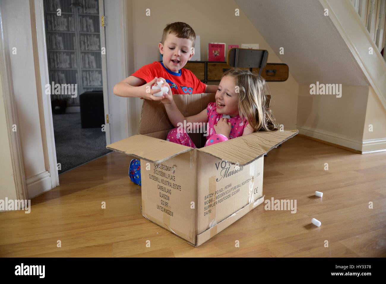 Children playing with an empty cardboard box Stock Photo - Alamy